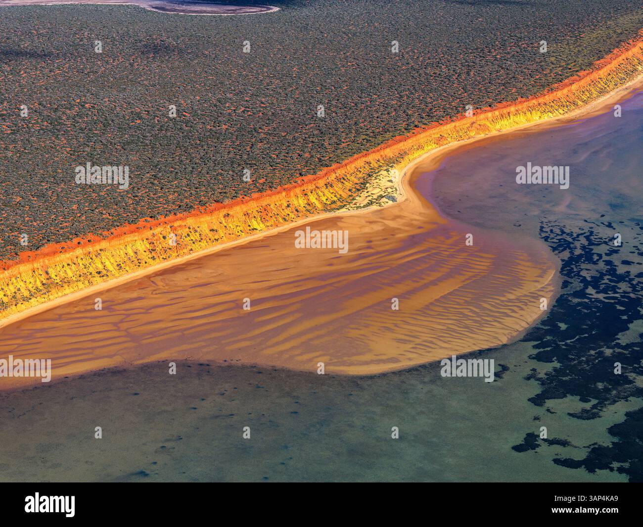 Aerial view of vibrant coastal shoreline with clear water and sand ...