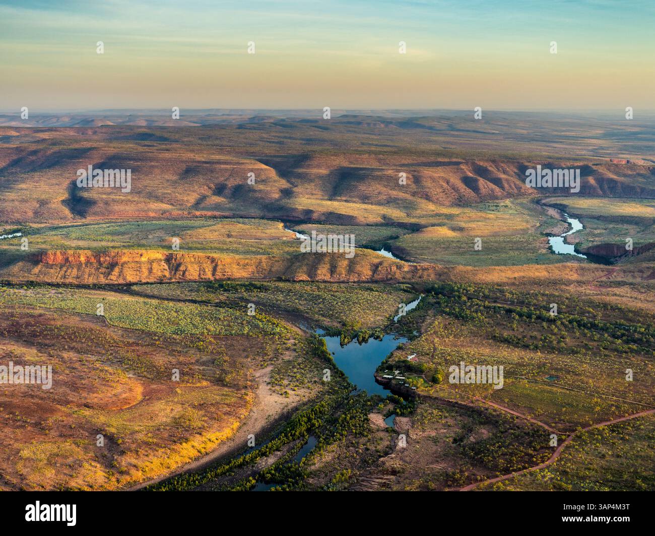 Aerial view of Chamberlain River Gorge at sunset with rugged terrain ...