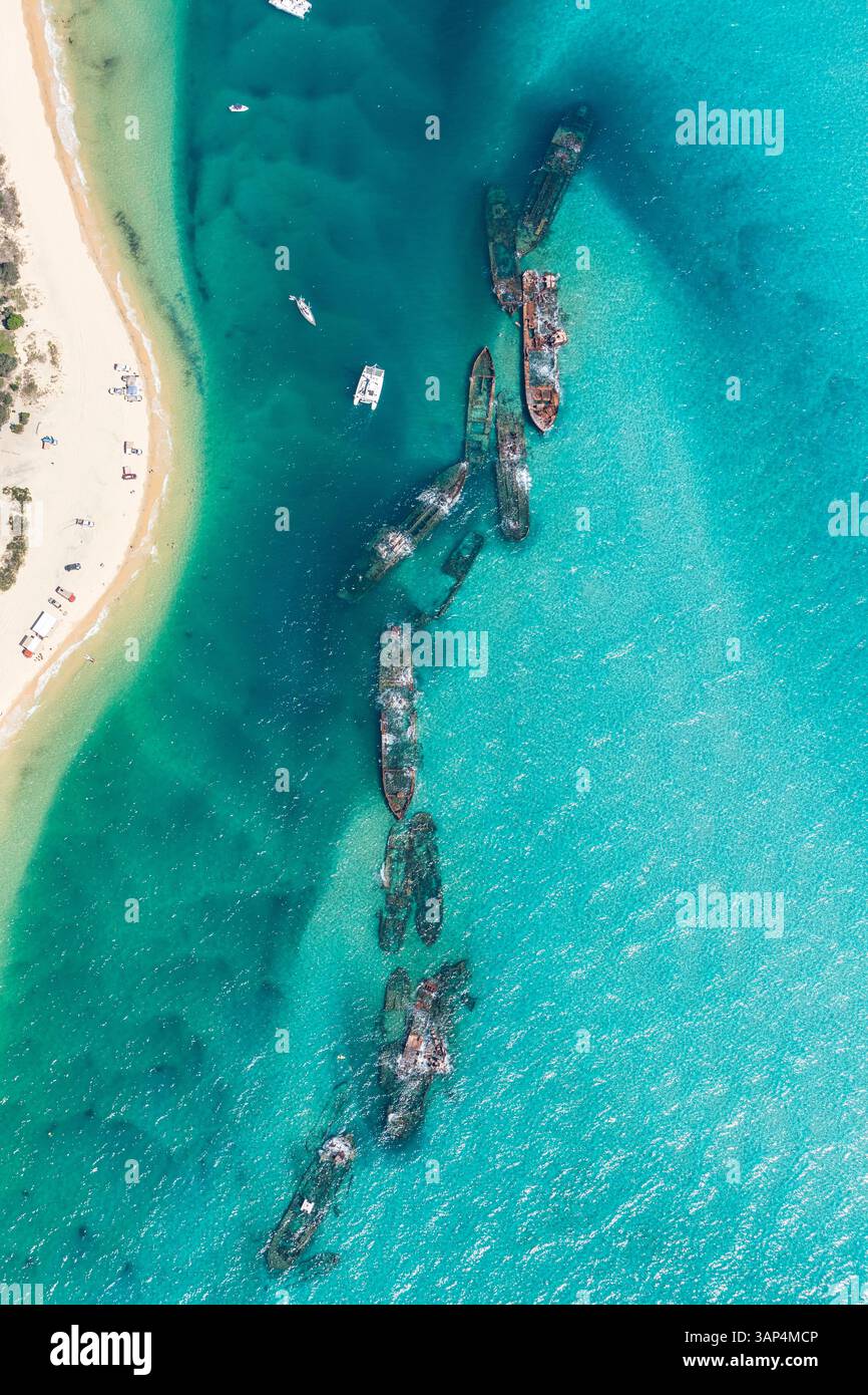 Aerial view of Tangalooma ship wrecks, clear water, and tropical beach ...