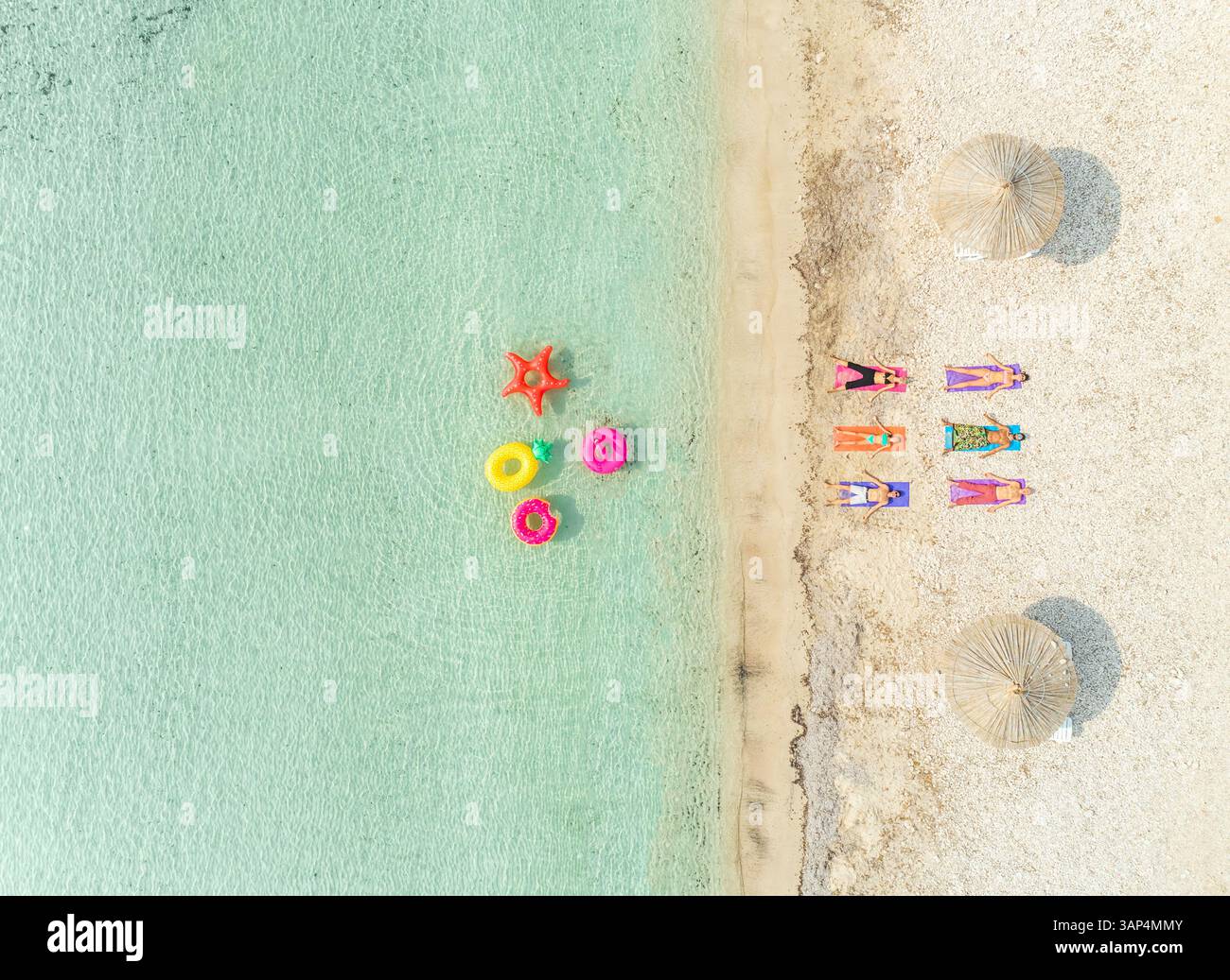 Aerial view of people lying in yoga pose on on the with inflatables ...