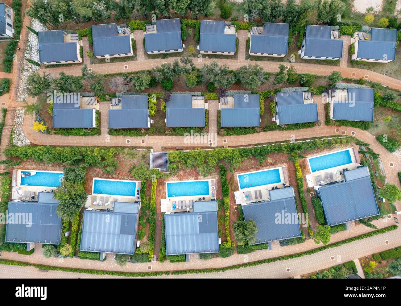 Aerial view of luxury camping resort with pools surrounded by greenery ...