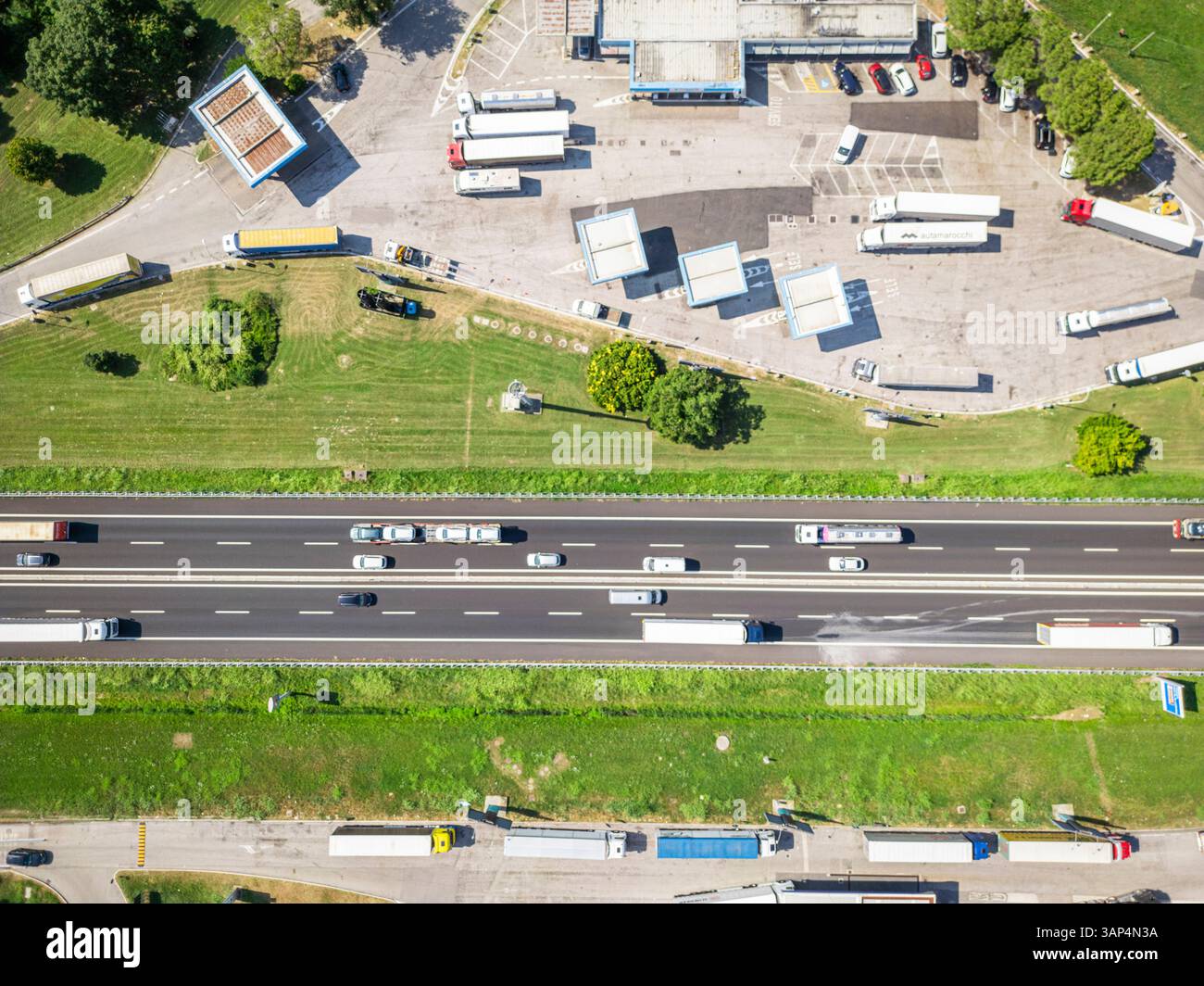 Aerial view of busy highway with trucks and cars near a gas station ...