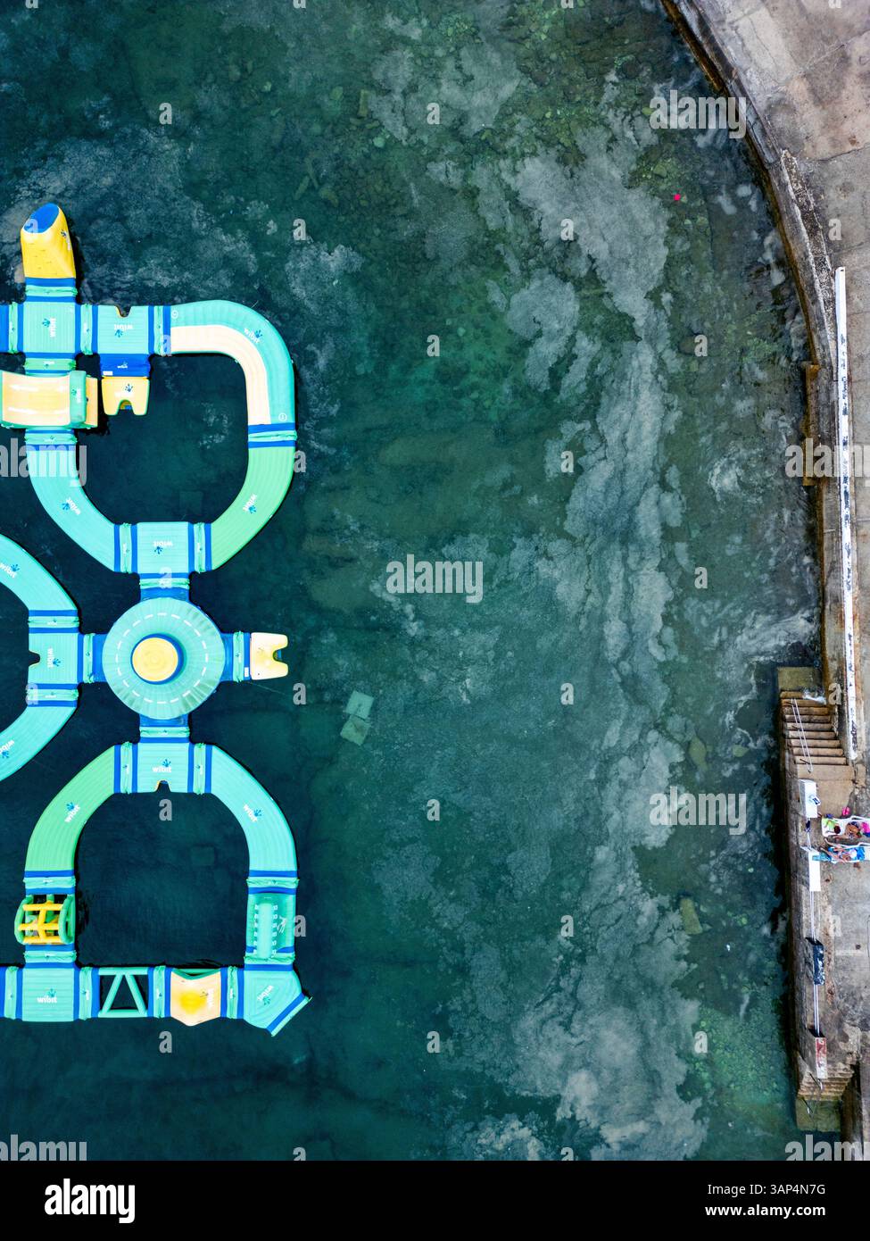 Aerial view of water park with algae accumulation around clear water ...