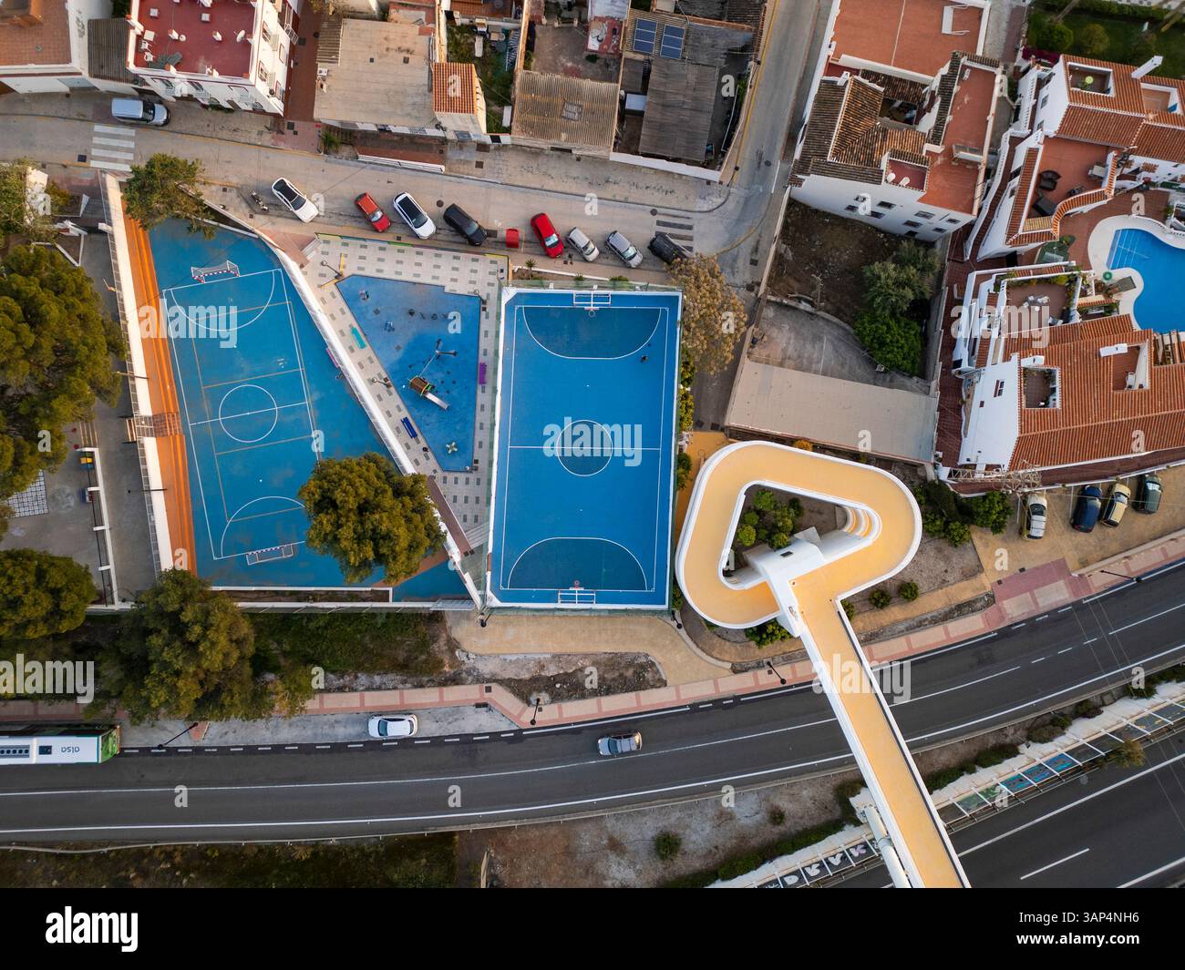 Aerial view of sport ground with basketball and tennis court surrounded ...
