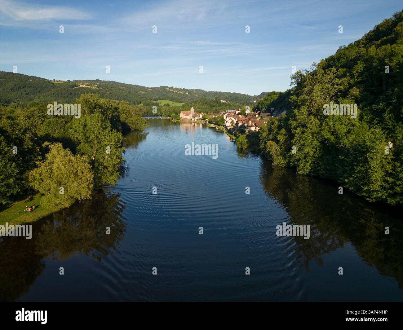 Aerial view of serene river meandering through picturesque village ...