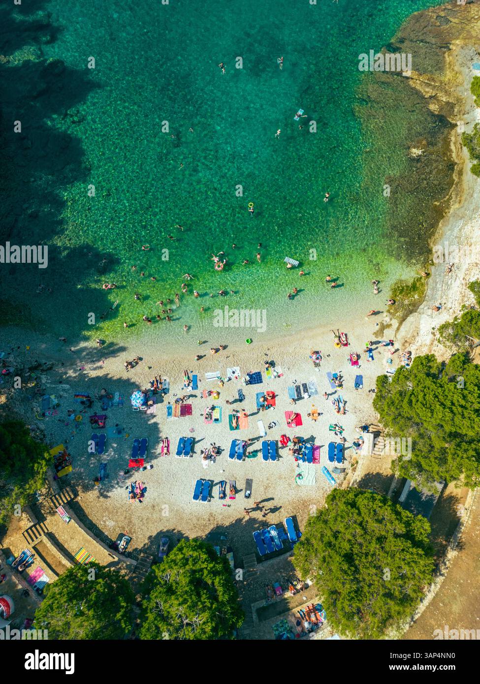 Aerial view of people relaxing at Gortanova beach, a narrow inlet with ...
