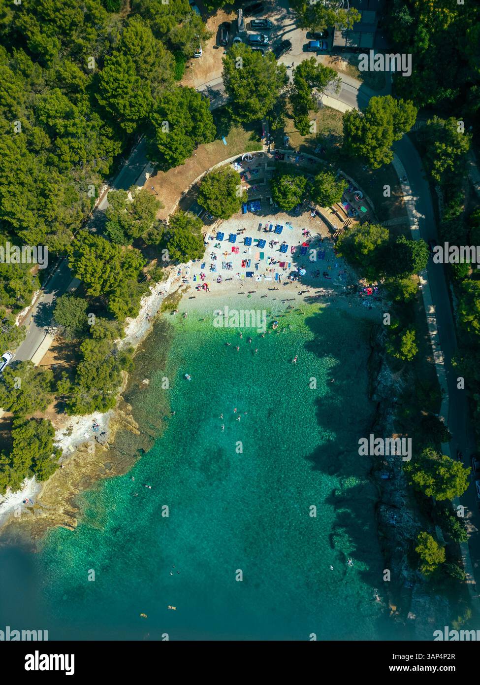 Aerial view of people relaxing at Gortanova beach, a narrow inlet with ...