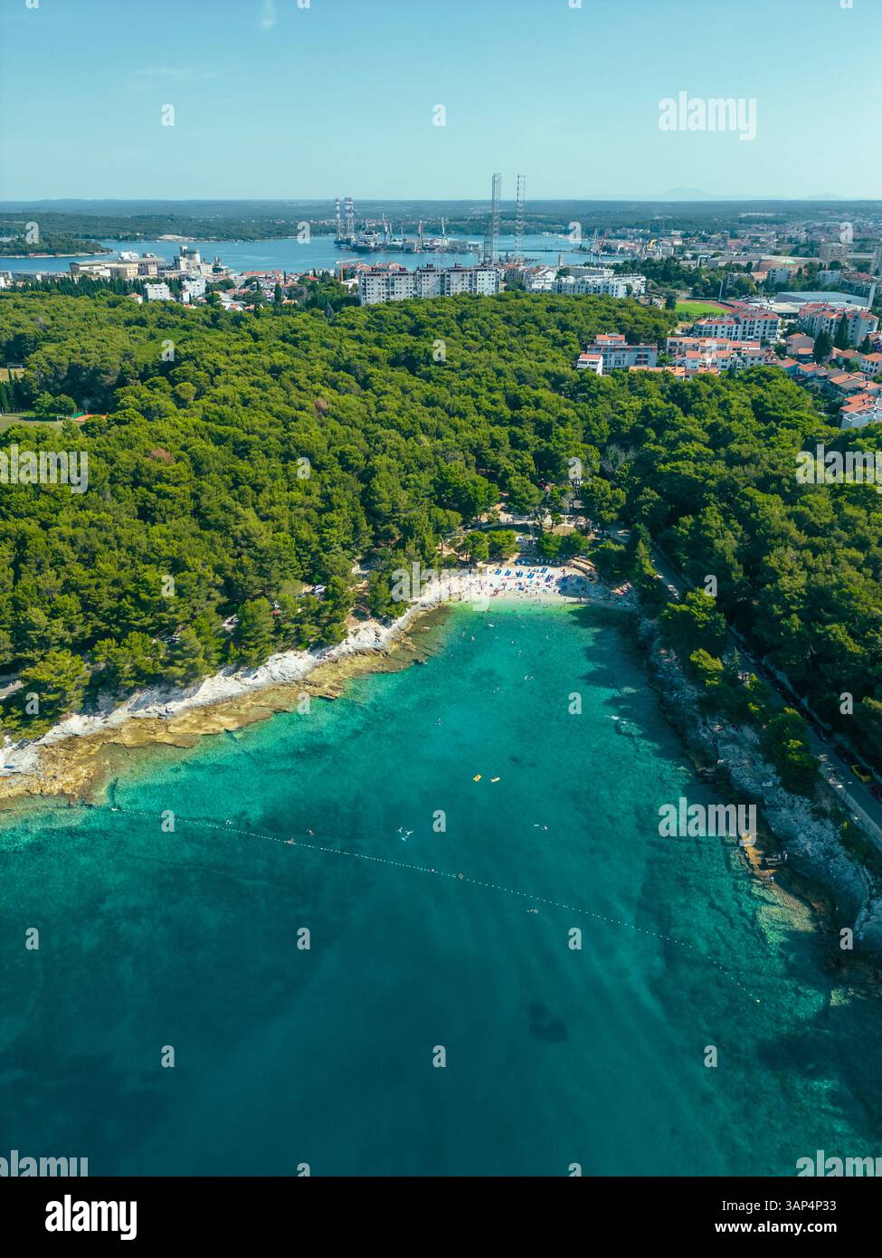 Aerial view of Gortanova beach, a narrow inlet with turquoise water ...