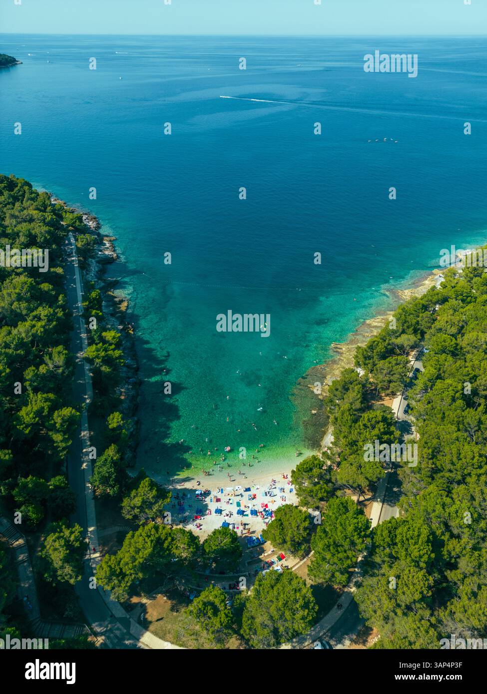 Aerial view of people relaxing at Gortanova beach, a narrow inlet with ...