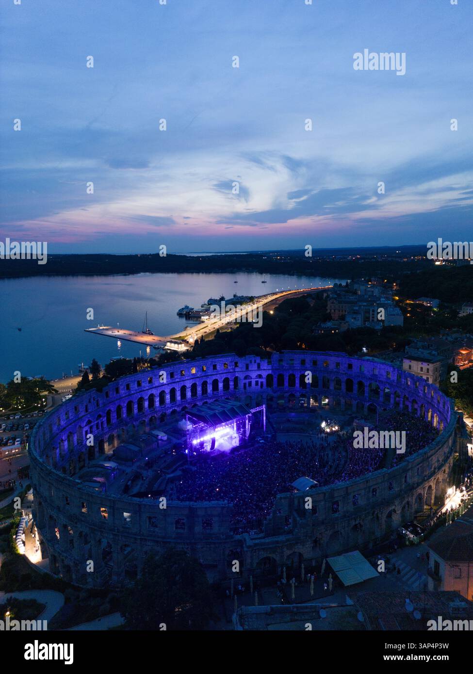 Aerial view of the Pula Amphitheater arena during a concert at sunset ...