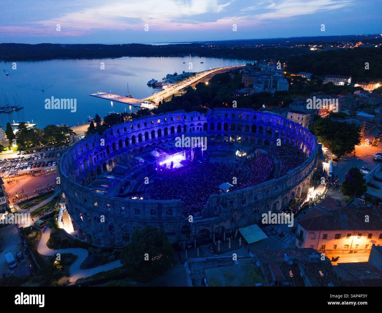 Aerial view of the Pula Amphitheater arena during a concert at sunset ...
