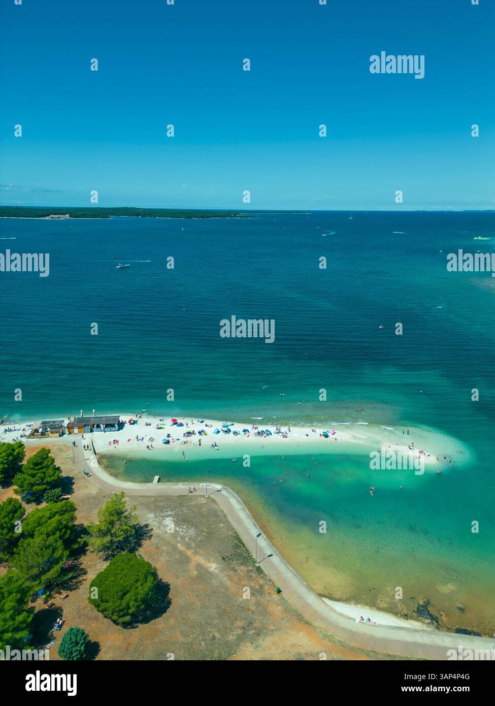 Aerial view of a small bar and restaurant with people on the beach ...