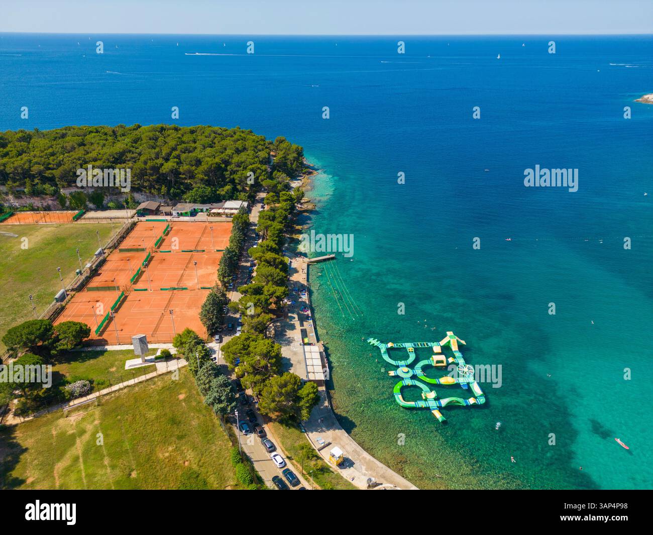 Aerial view of Tennis courts and a water playground for kids along the ...