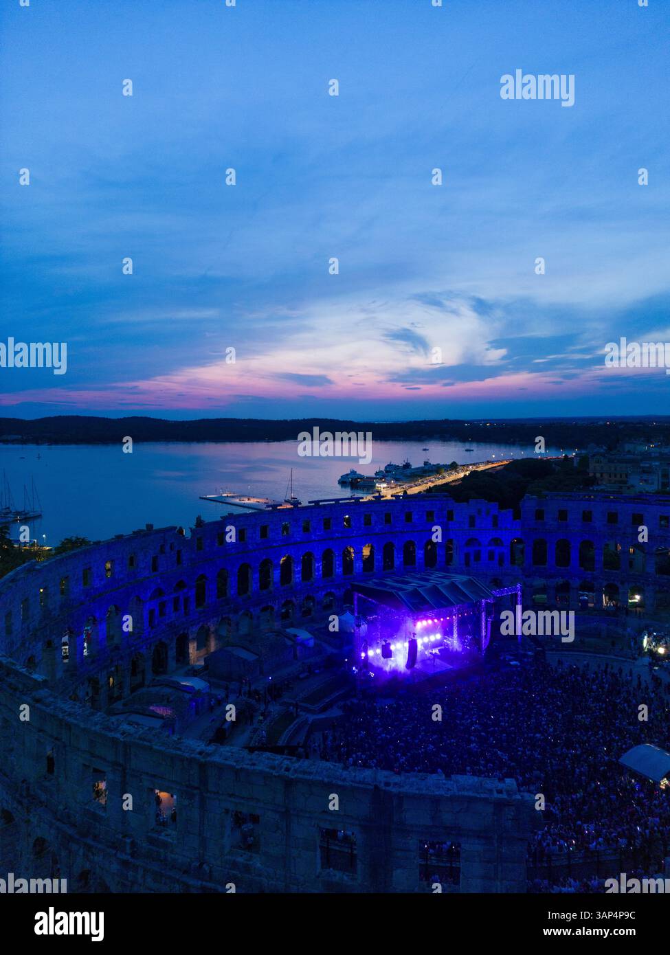 Aerial view of the Pula Amphitheater arena during a concert at sunset ...