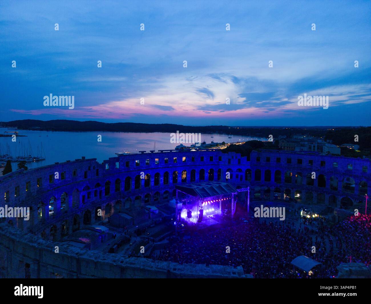 Aerial view of the Pula Amphitheater arena during a concert at sunset ...