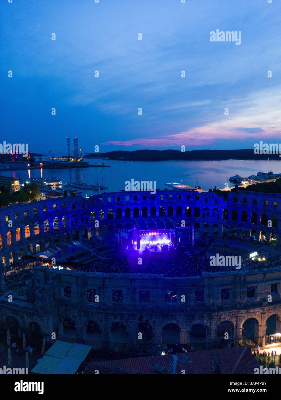 Aerial view of the Pula Amphitheater arena during a concert at sunset ...