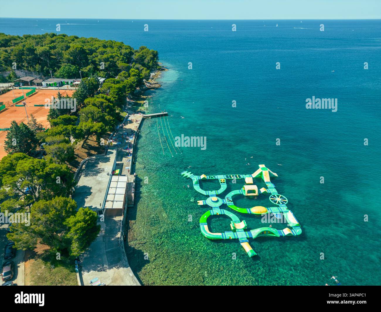 Aerial view of Tennis courts and a water playground for kids along the ...