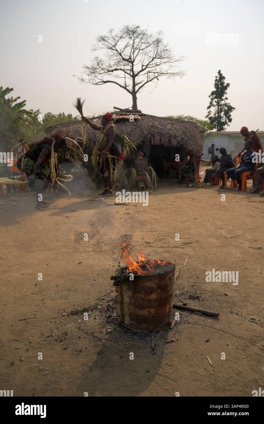 Ritual fire lit in front of the temple where a Bwiti ceremony has been ...