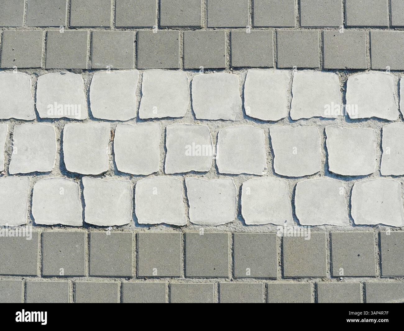 paved surface with white stones hinting at a zebra crossing. Structure ...
