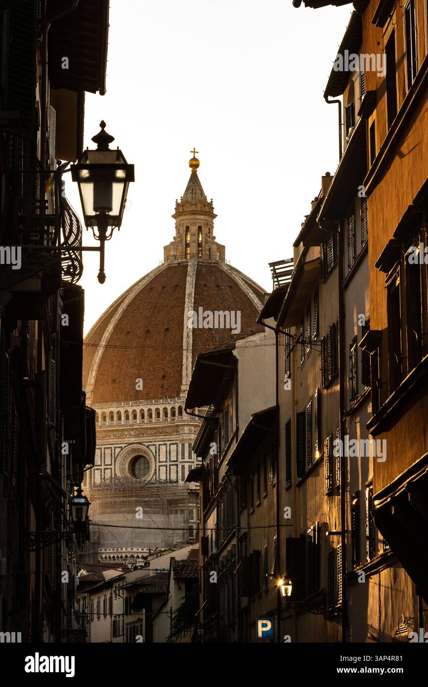 Florence Cathedral's dome (Duomo) framed by narrow city street and ...