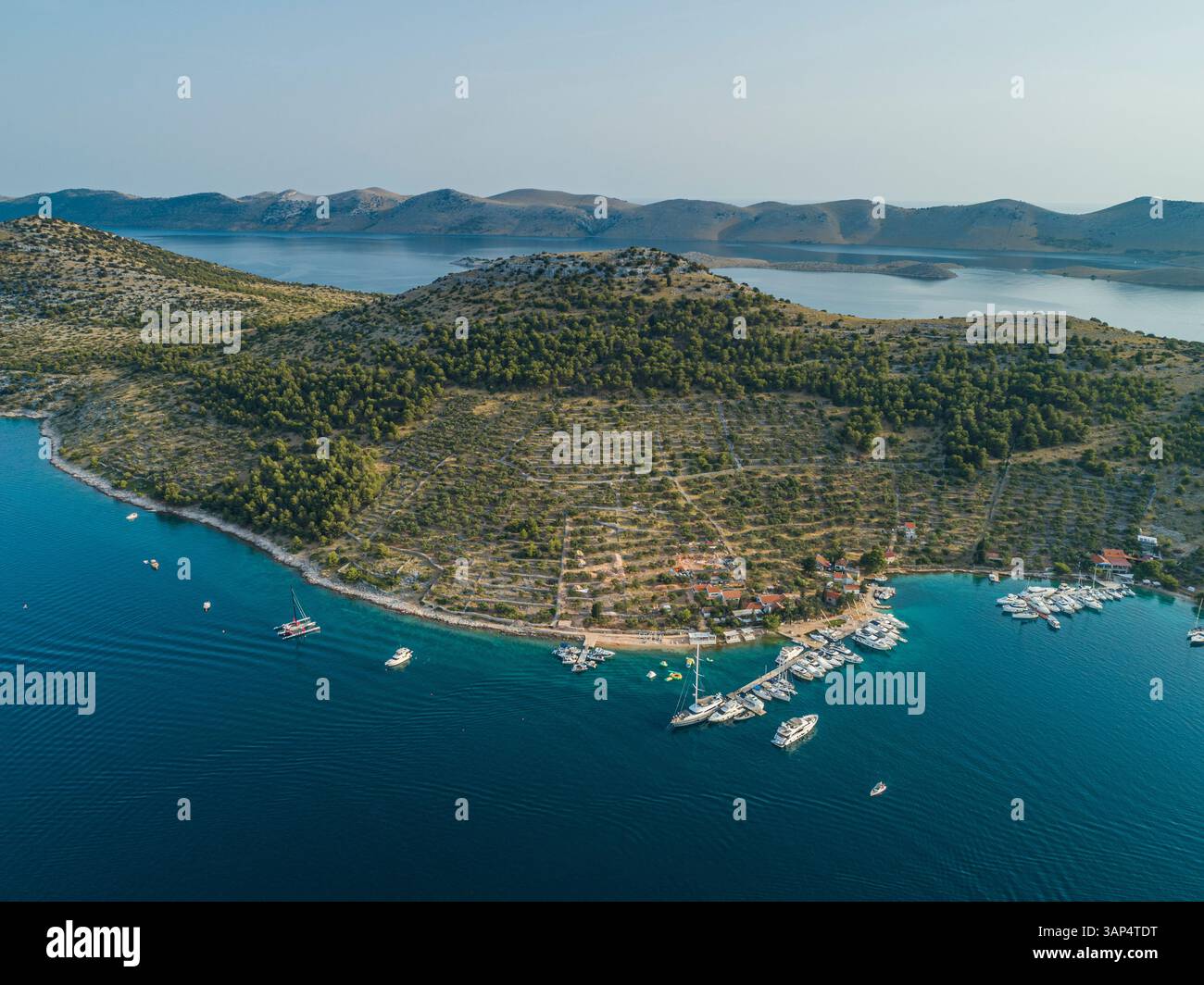 Aerial view of sailing boats anchored along the coastline near a ...