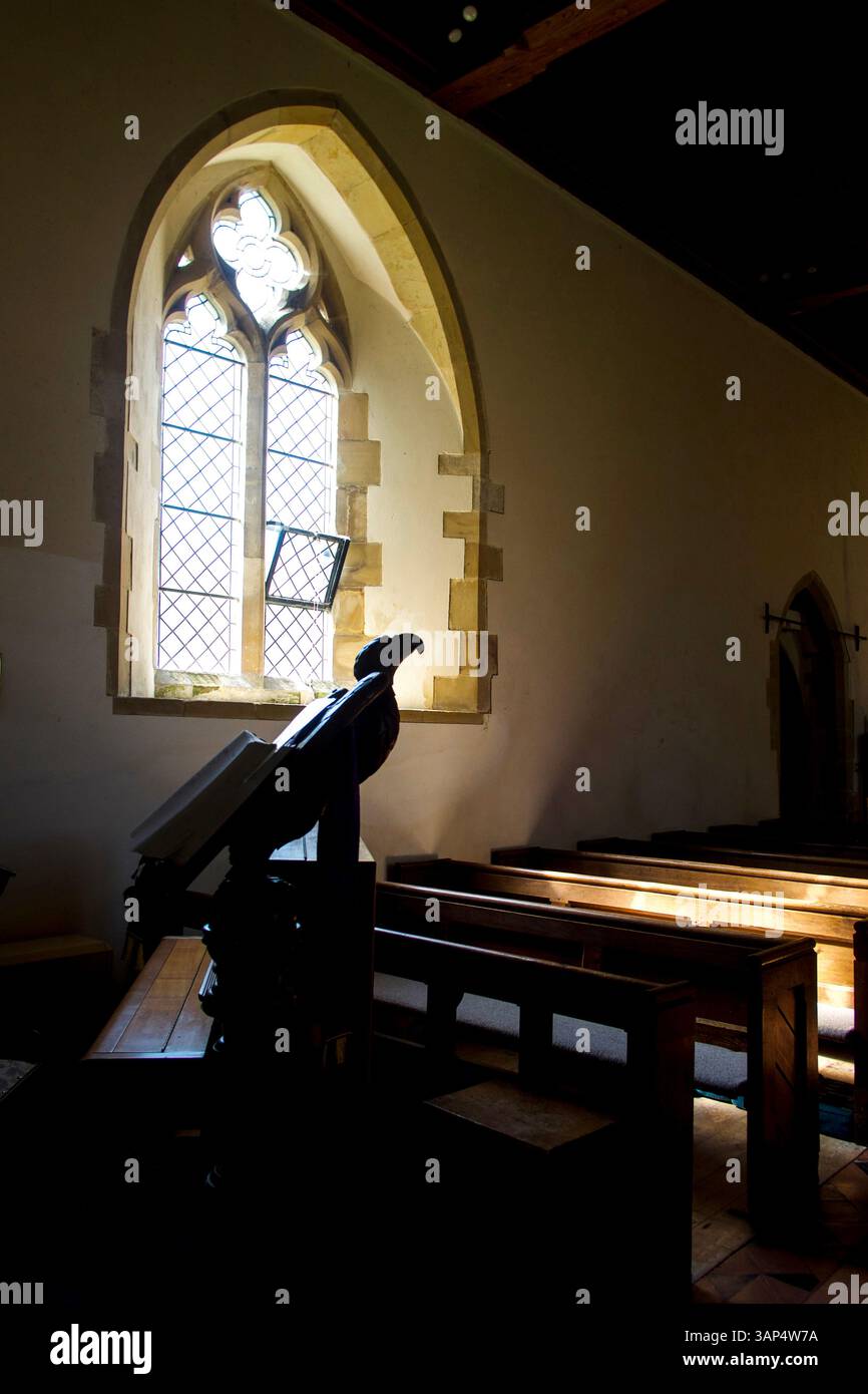 Church interior, light streaming through two arched church windows ...