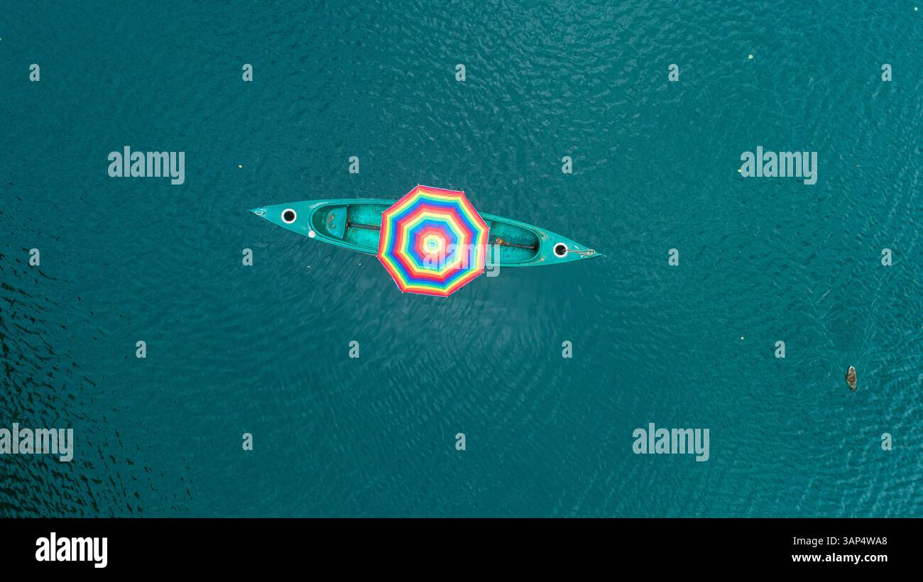 Aerial view of a person crossing the Mreznica river with a small kayak ...