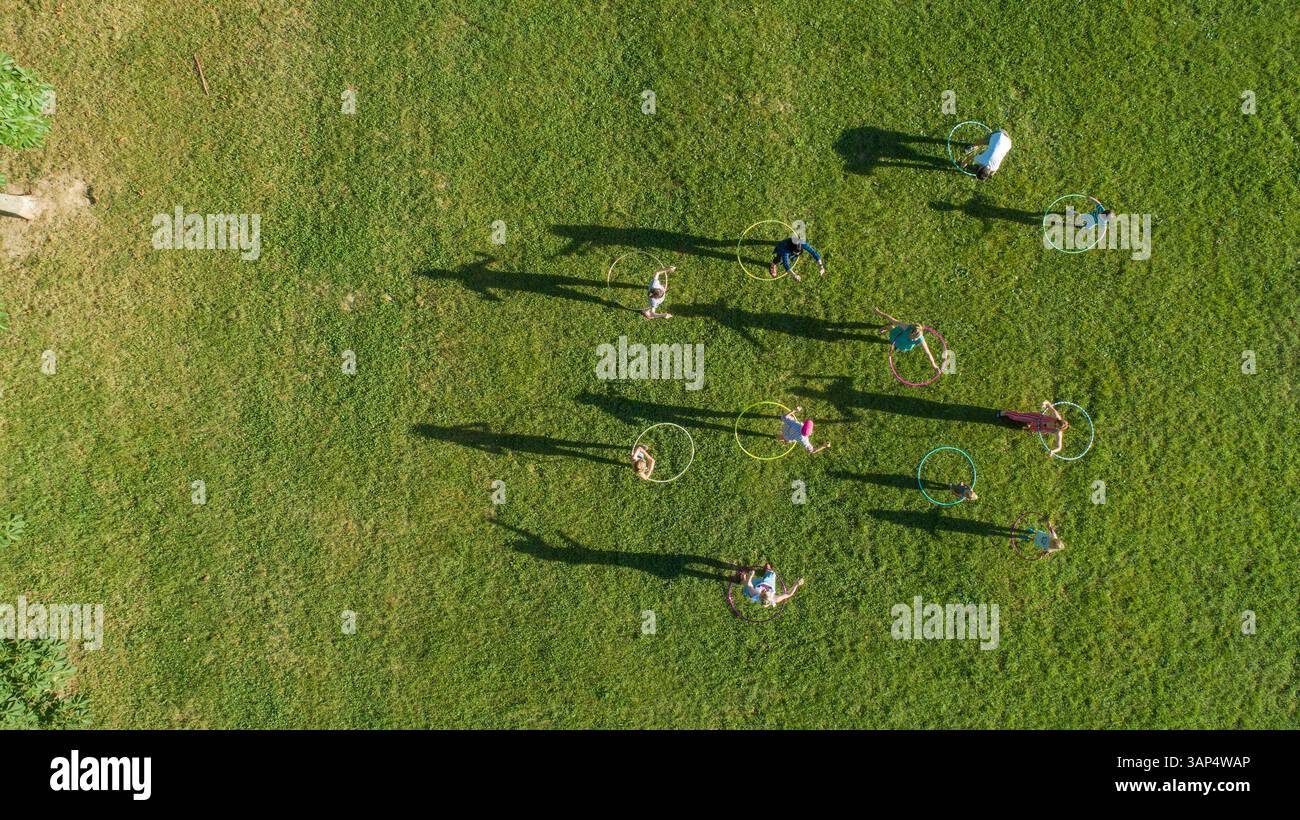 Aerial view of persons doing Hula Hoop in group at Tudmana Park, a ...