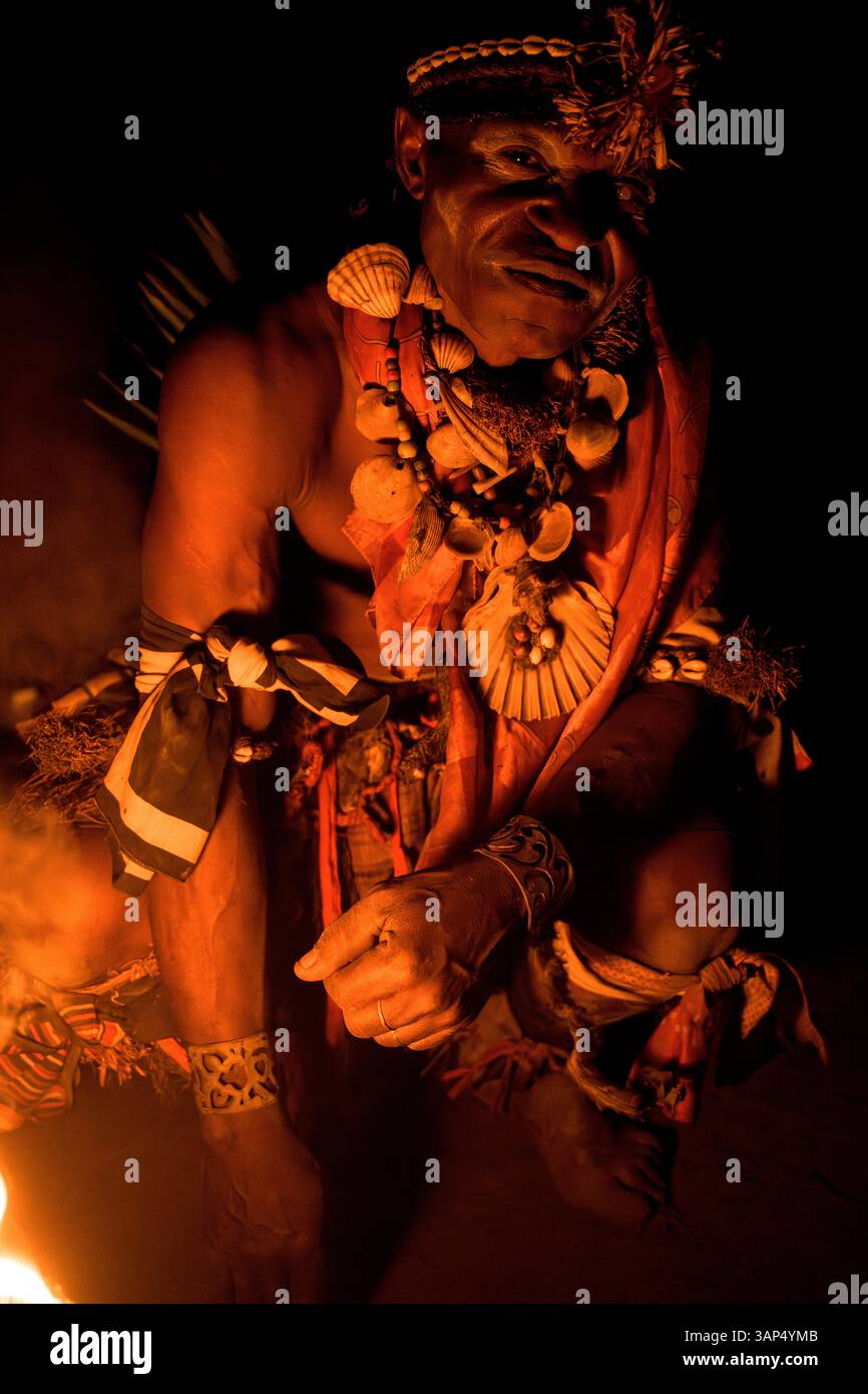 Portrait of a man by the sacred fire, dressed in a ritual costume ...