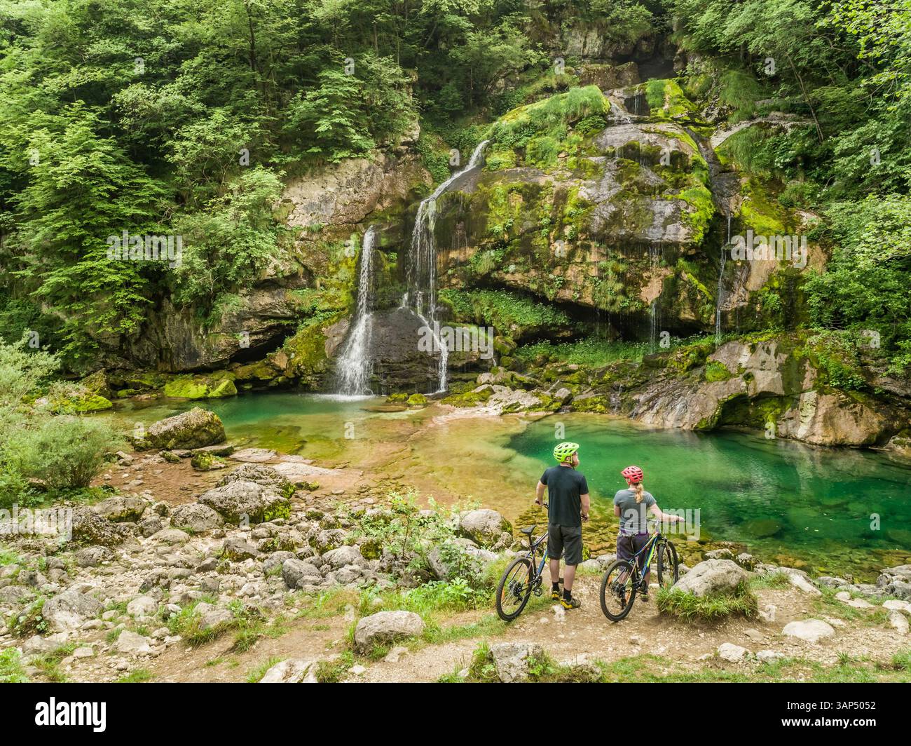 Aerial view of cyclists at Virje waterfall in Soca valley, Slovenia ...