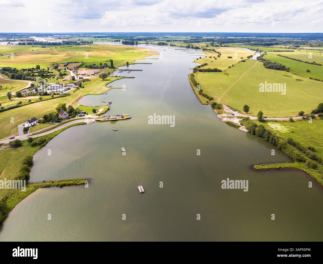 Aerial view of river Nederrijn with groynes and crossing ferry between ...