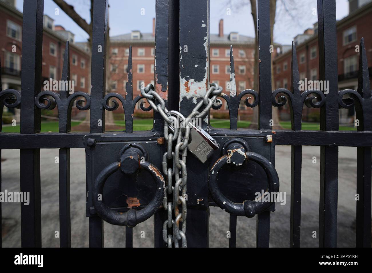 Gates are padlocked outside dormitories at Harvard University, Monday ...