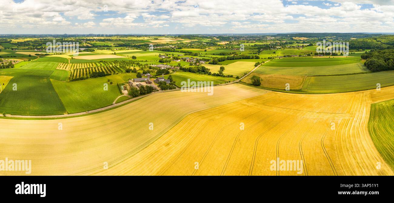 Aerial panorama of hilly countryside with cropland, meadows and fruit ...