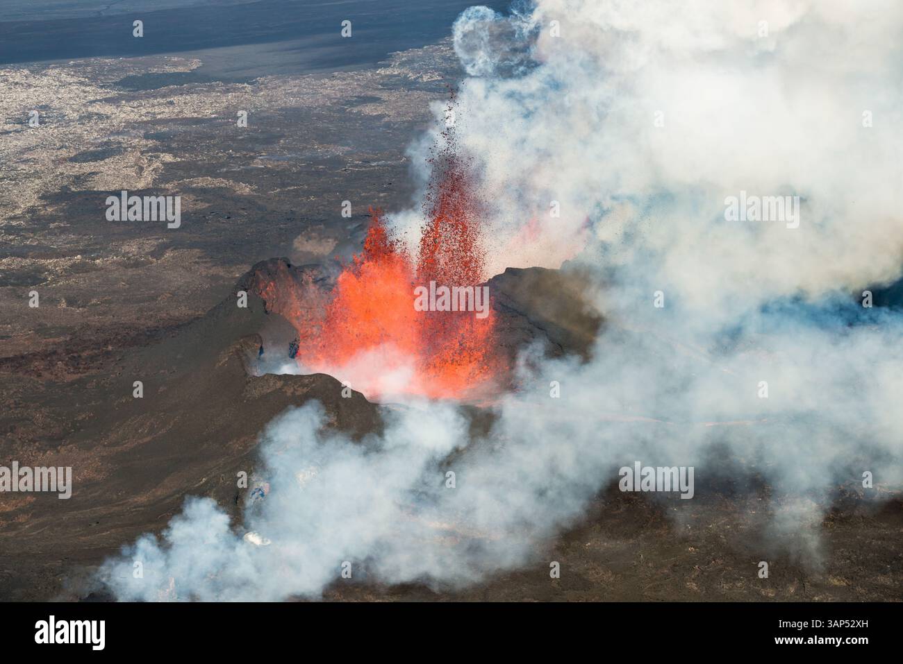Aerial view of crater with spewing lava, smoke and gases during the ...