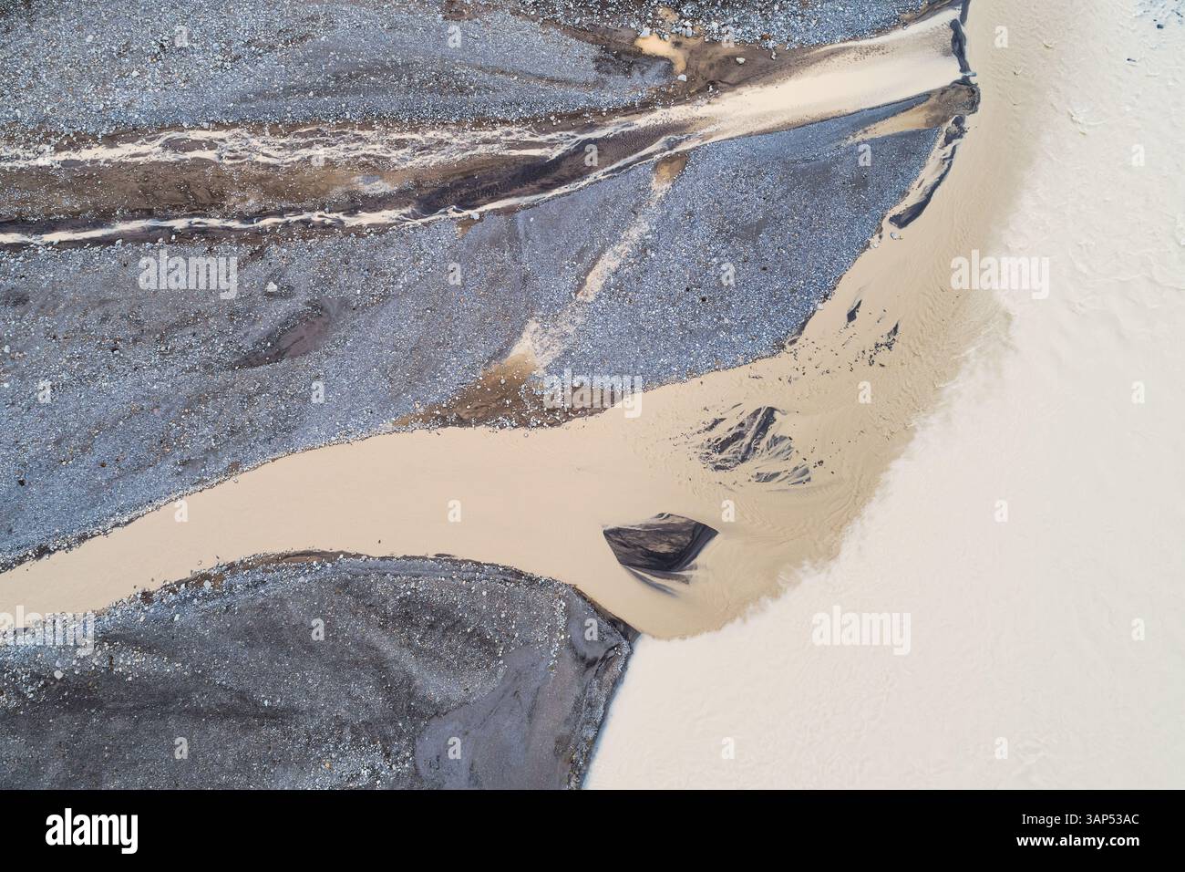 Abstract aerial view of two rivers with different sediment colours ...