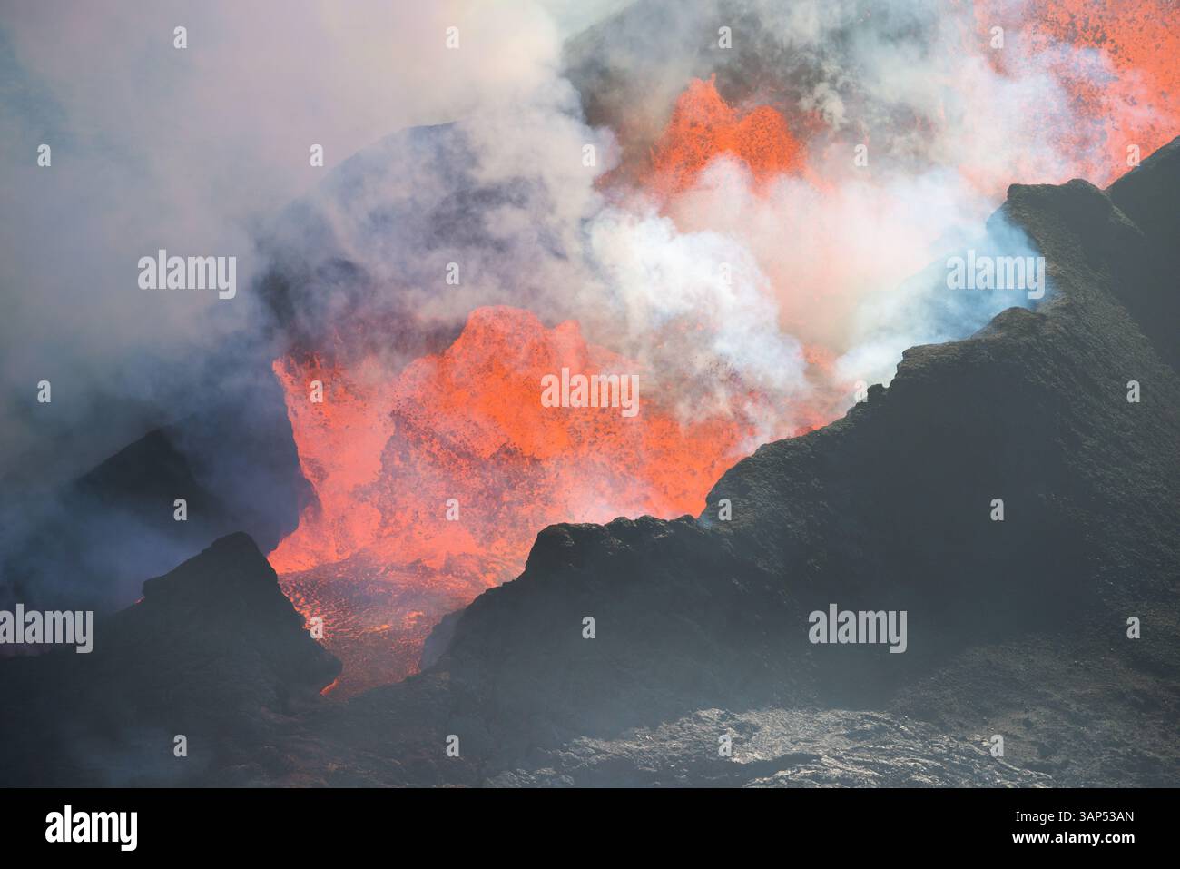 Aerial view of crater with spewing lava, smoke and gases during the ...