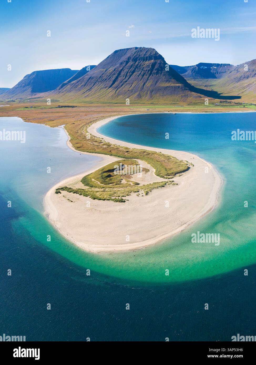 Aerial view of a small peninsula with a beach in a fjord in front of a ...