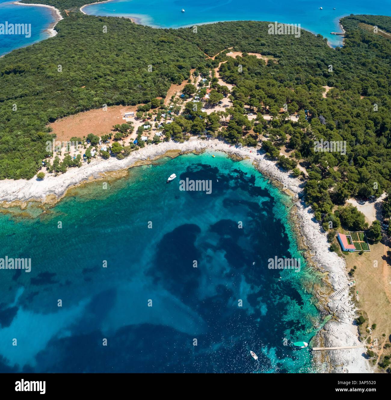 Aerial view of a campsite on the Veli Rat bay with turquoise water ...