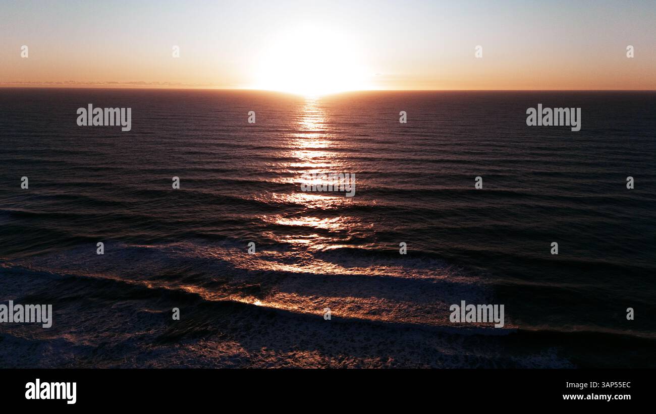 Calm ocean waves reflecting sunset hi-res stock photography and images ...