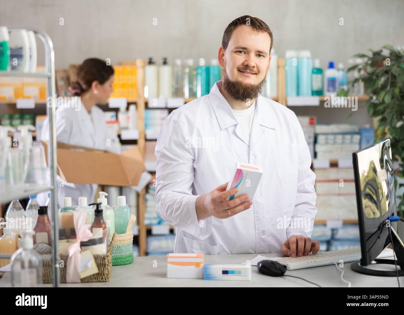 Male pharmacist standing behind counter in pharmacy Stock Photo - Alamy