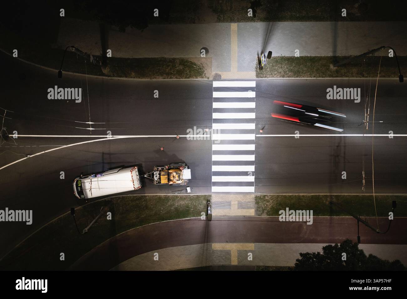 Aerial view of new pedestrian crossing zebra being painted on street in ...