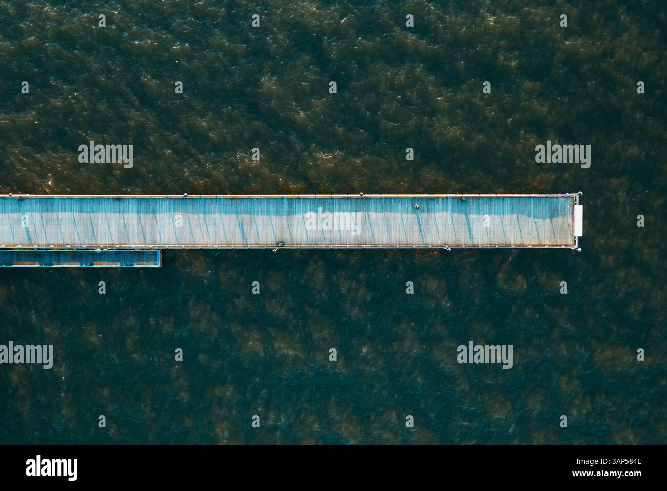 Aerial view of straight line shape pedestrian bridge in Baltic sea near ...