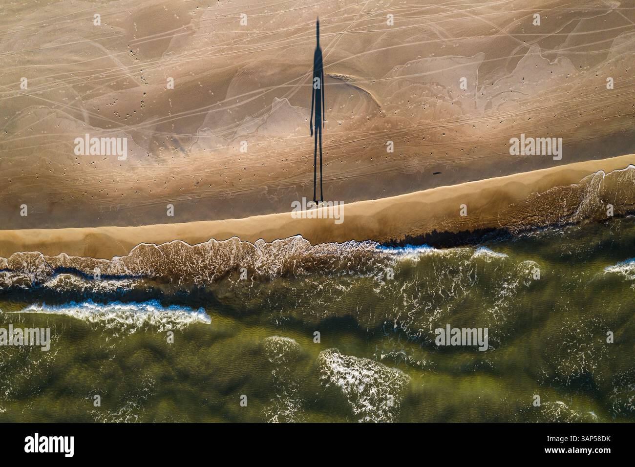 Aerial view of person silhouette shadow standing on Baltic sea shore ...