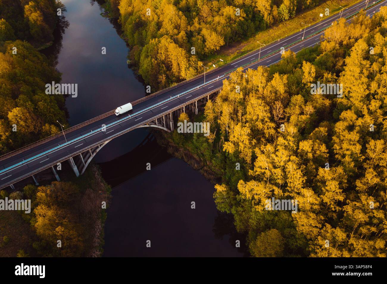 Aerial view of white cargo truck crossing bridge on highway near Kaunas ...