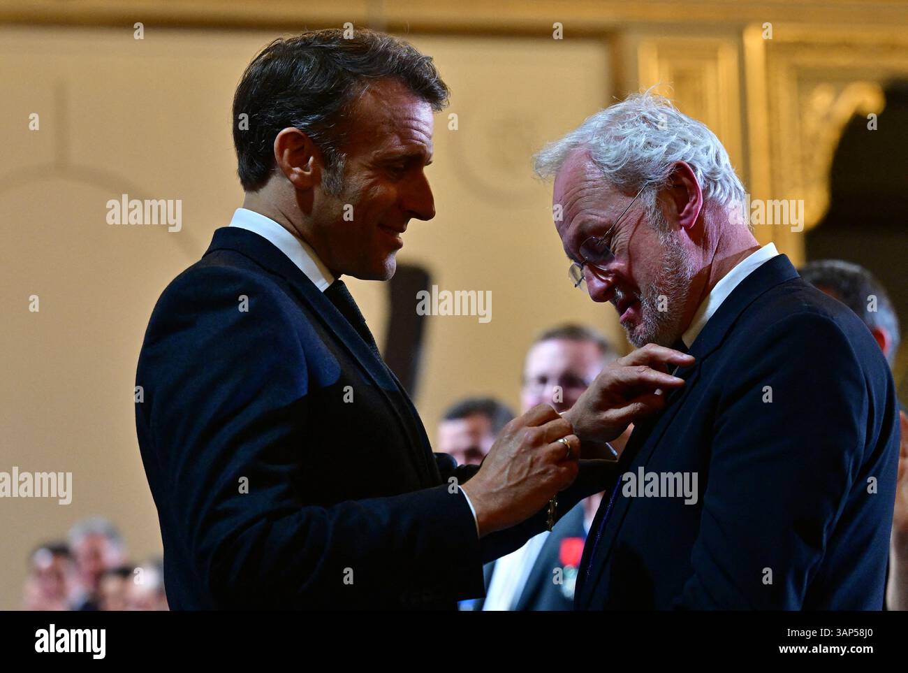Paris, France. 15th Apr, 2025. French President Emmanuel gives a medal ...