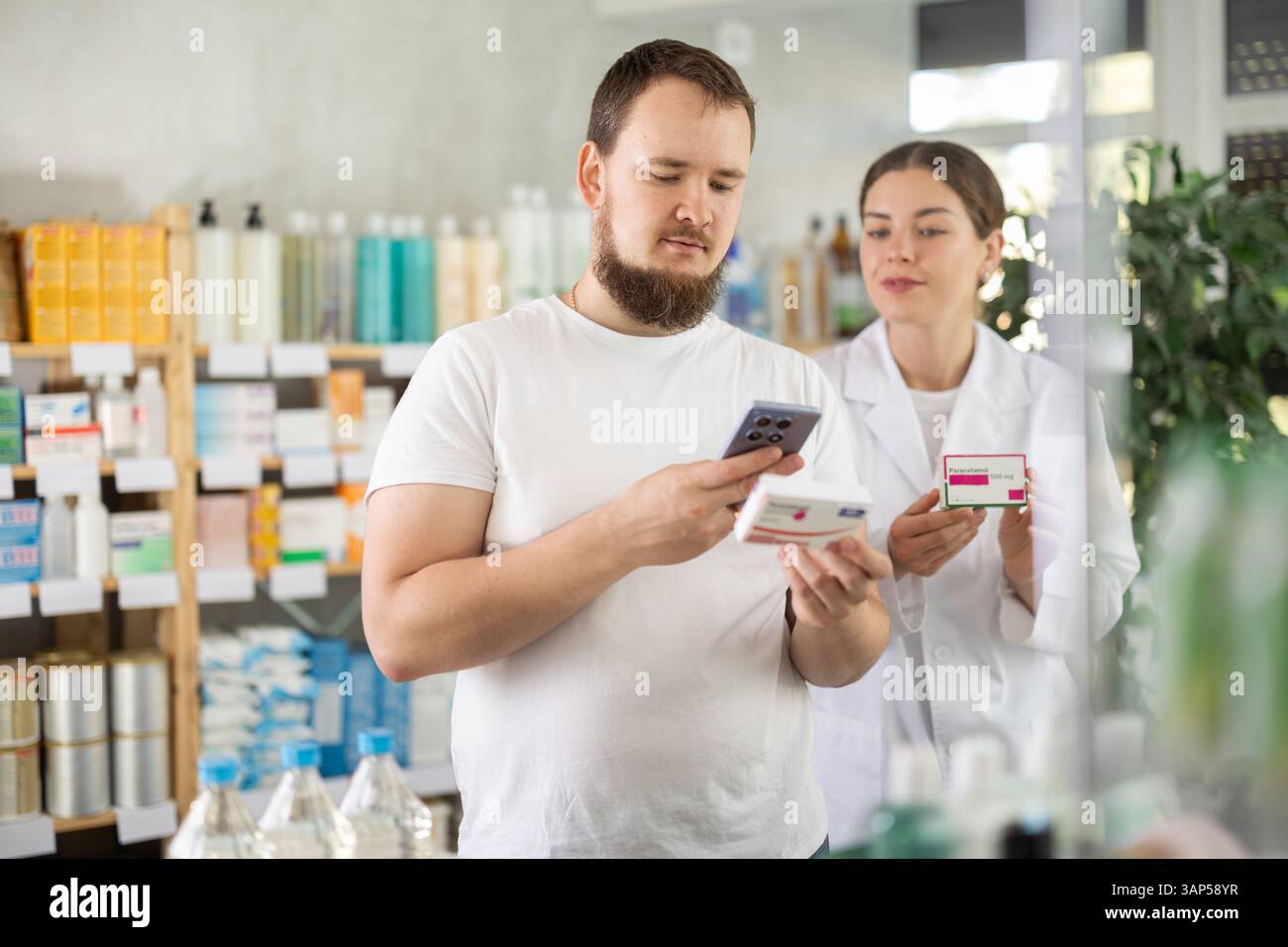 Man scans QR code on box paracetamol pills label. Female pharmacist ...
