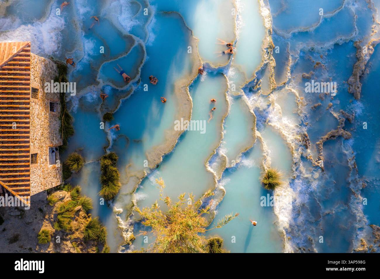 Aerial view of Saturnia spa with sunbathers at Hot Spring, Manciano ...