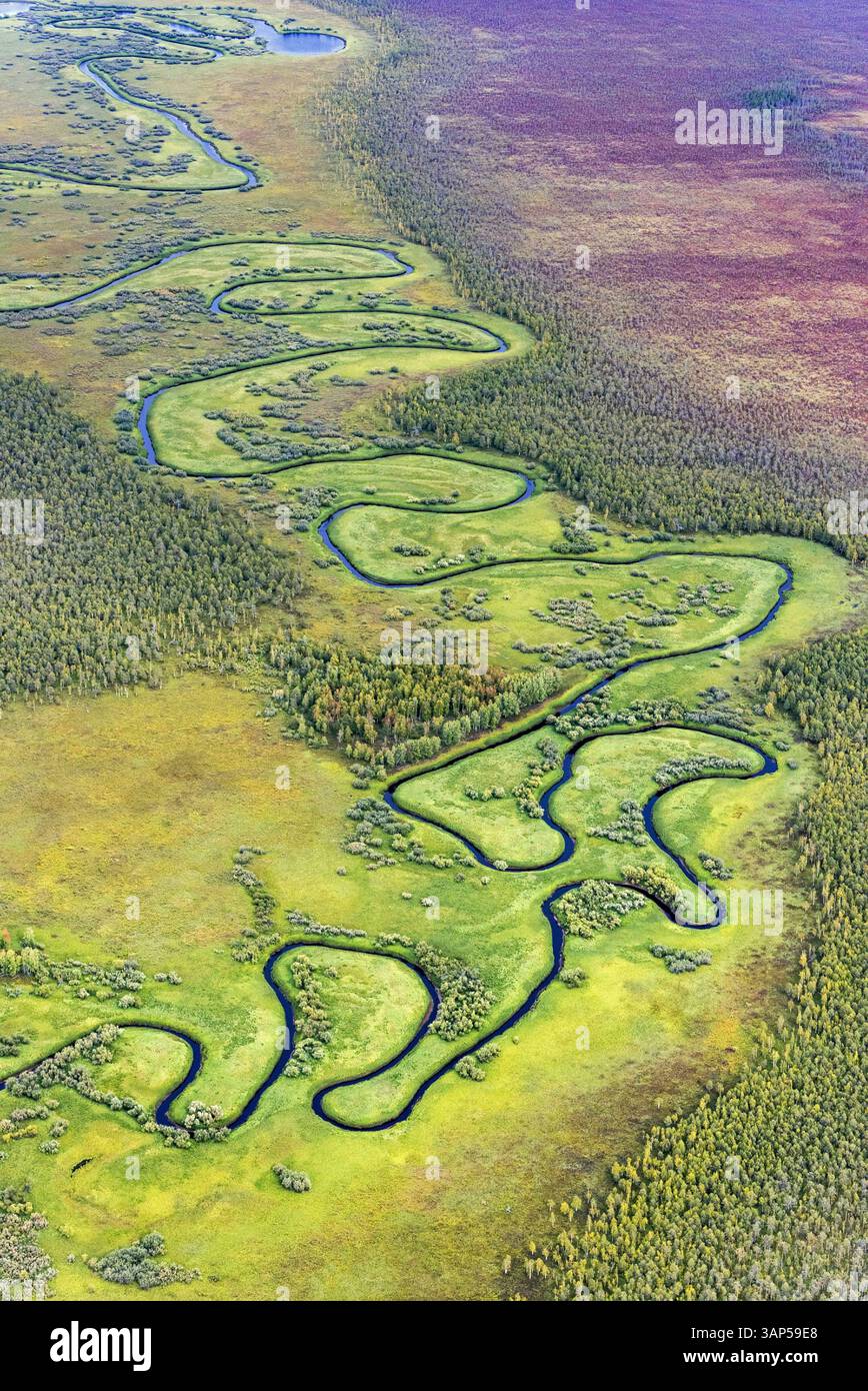 Aerial view of a meandering river surrounded by pristine forest and ...
