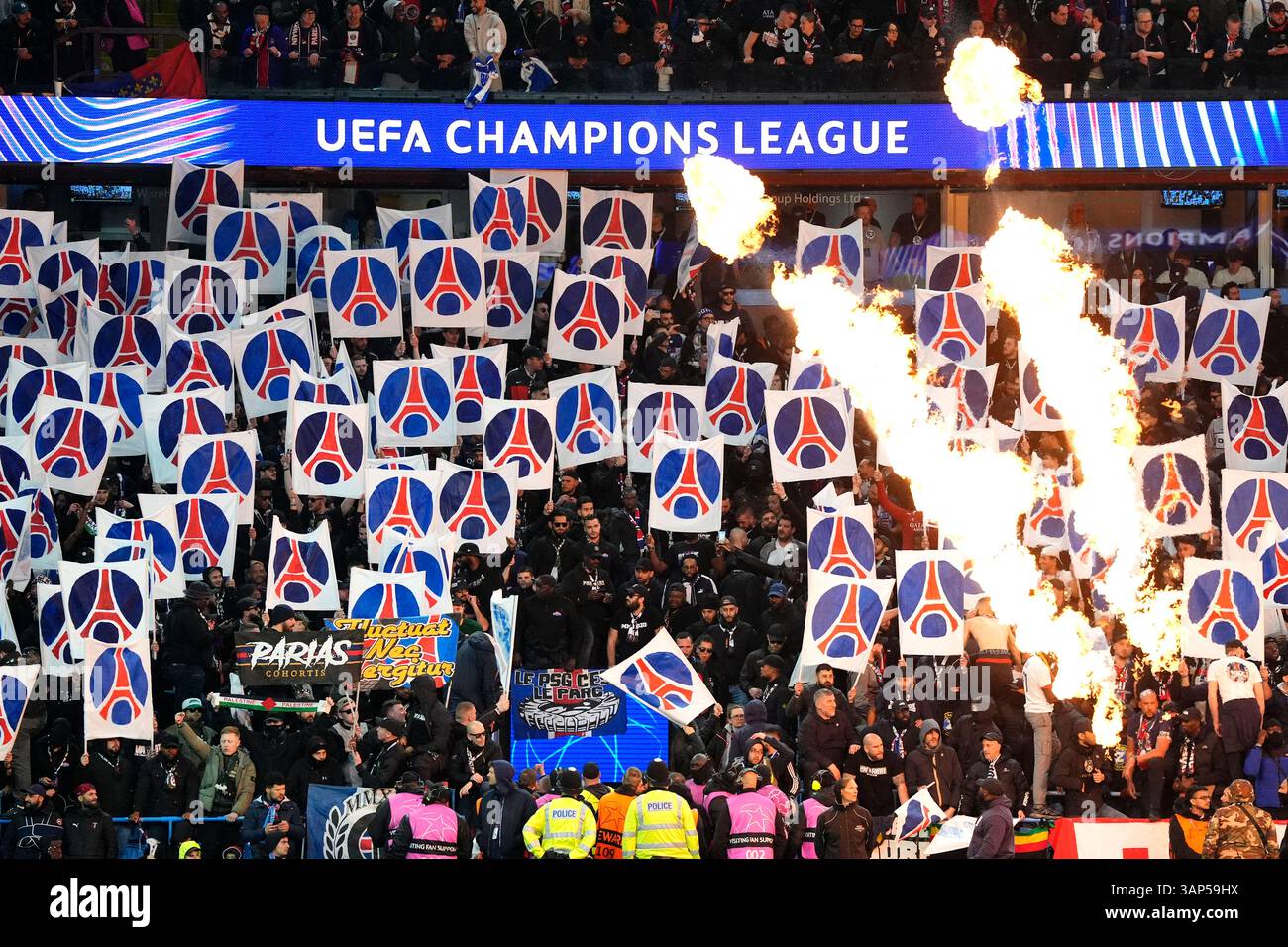 Paris Saint-Germain fans hold up banners with the club badge as ...