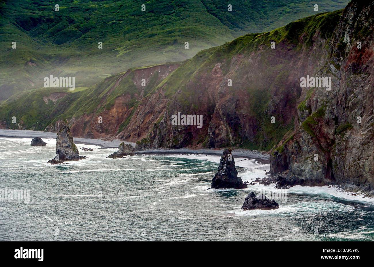 Aerial view of rugged cliffs and rock formations by the sea with black ...